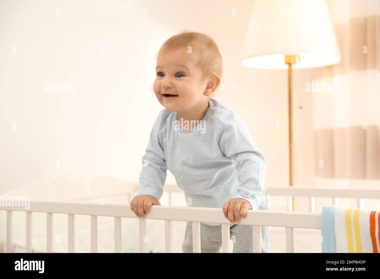 Cute little baby in crib at home Stock Photo - Alamy