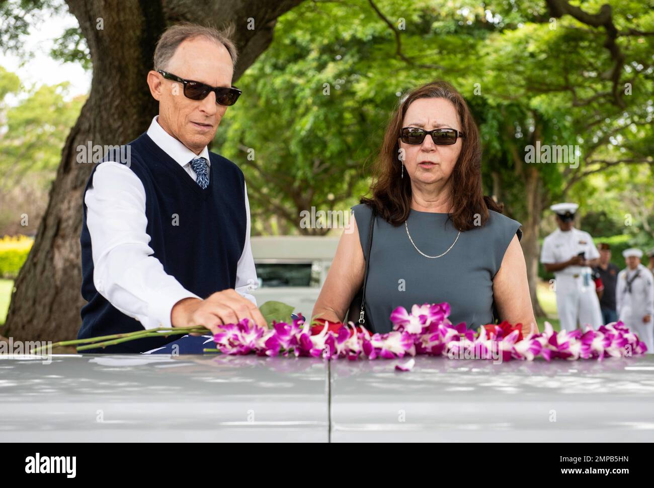 John Basden and his wife, Dolores Basden, place flowers on the casket ...