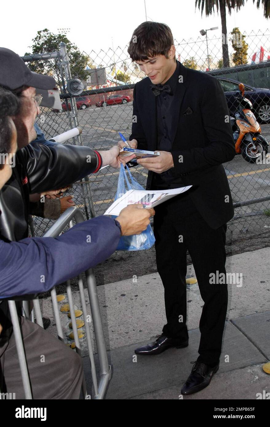 Ashton Kutcher looks dapper in a black suit, shirt and bowtie as he arrives at the "Jimmy Kimmel ...