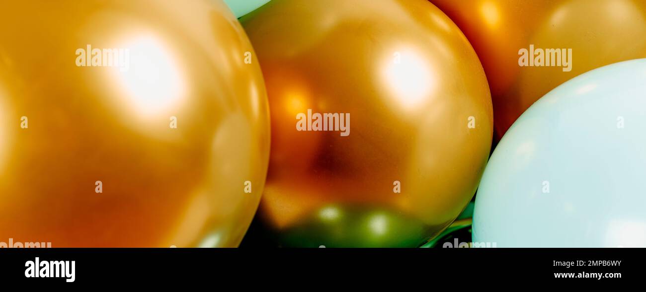 closeup of some elegant golden balloons as a decoration for a birthday ...