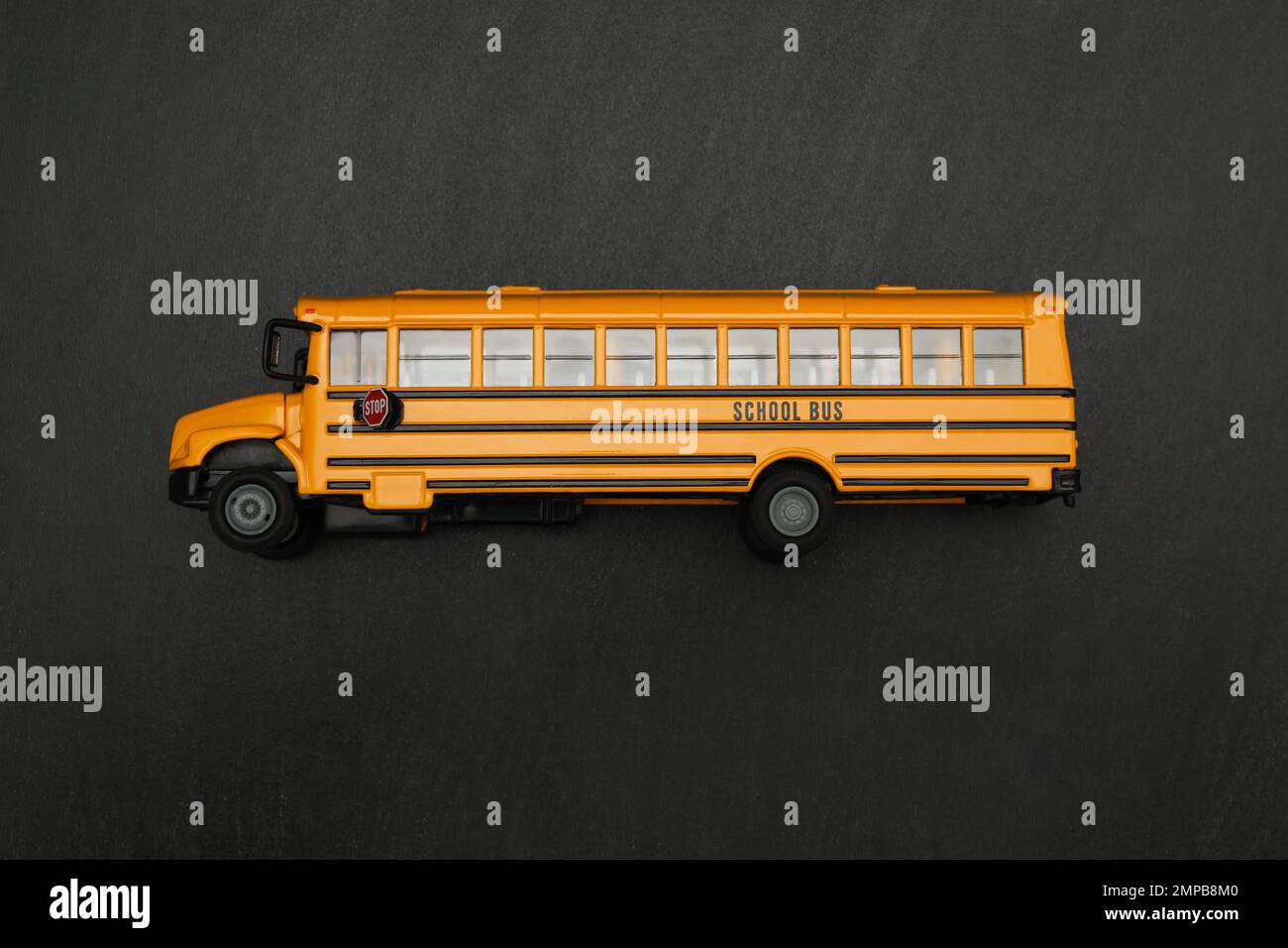 Yellow school bus on black background, top view. Transport for students ...