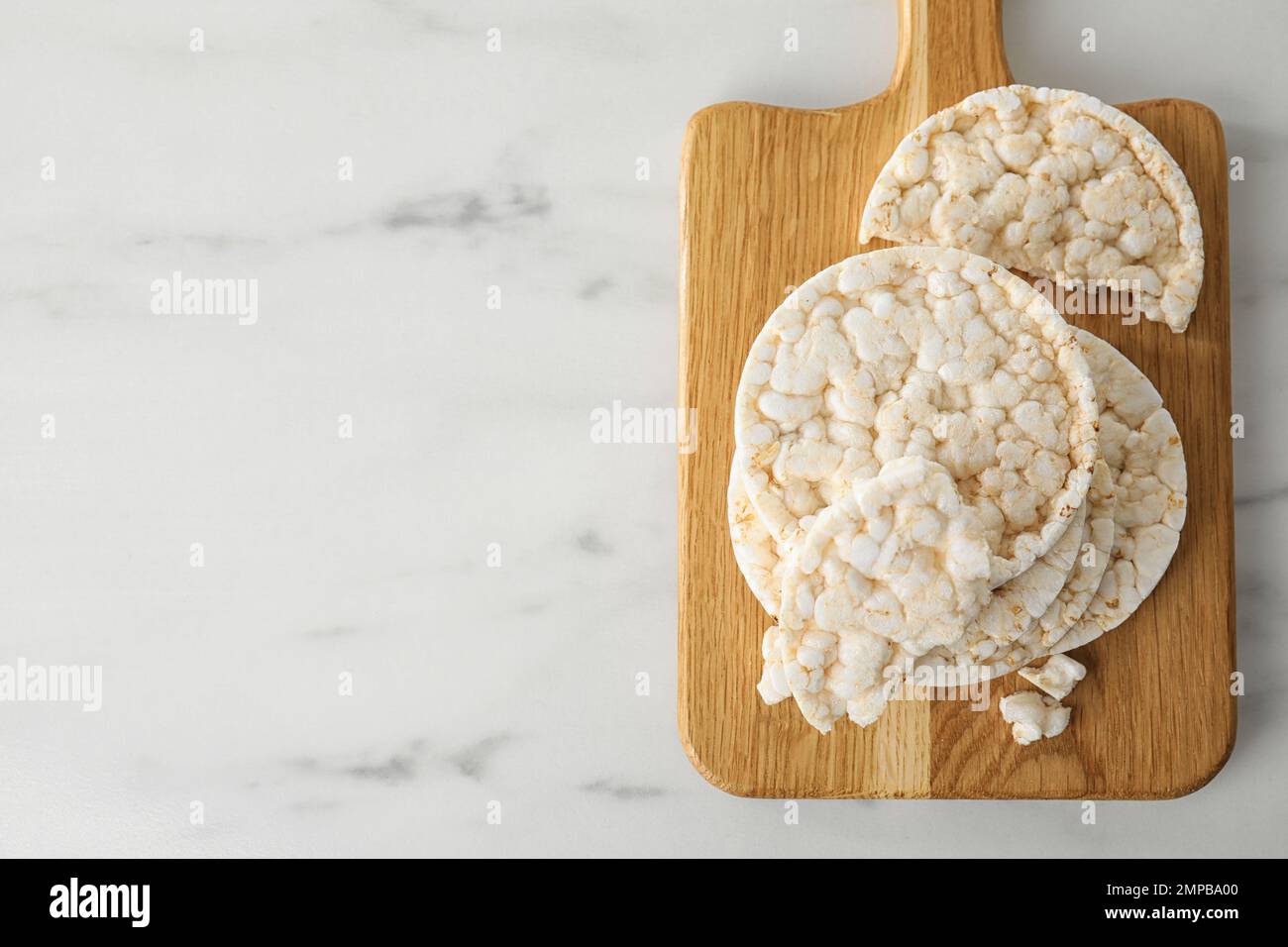 Puffed rice cakes on white wooden table, top view. Space for text Stock ...
