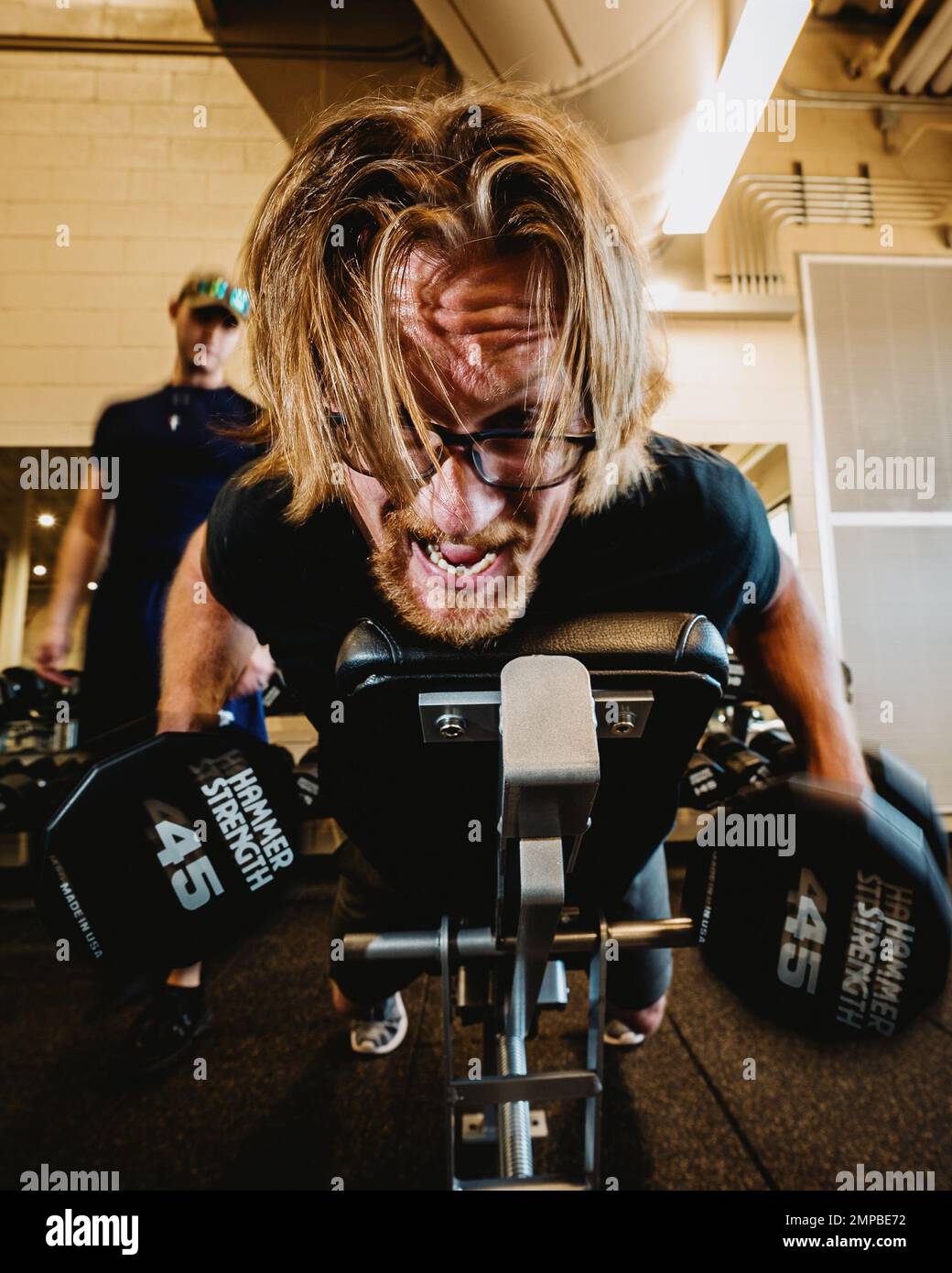 KT Kelley, Mix 107.5 radio host, performs dumbbell rows while preparing ...