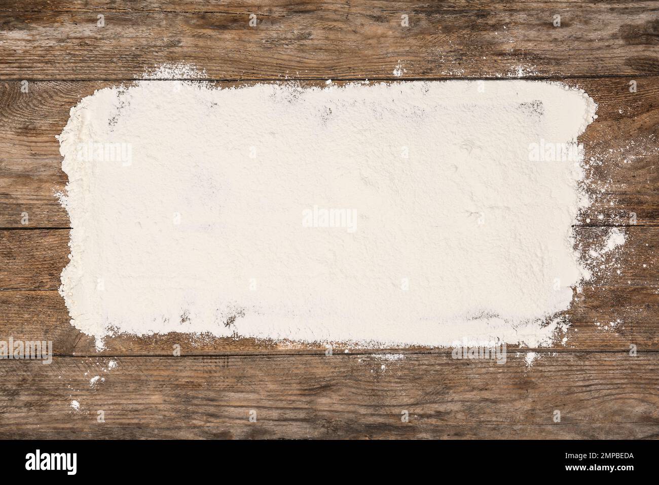 Pile of flour on wooden table, top view Stock Photo - Alamy