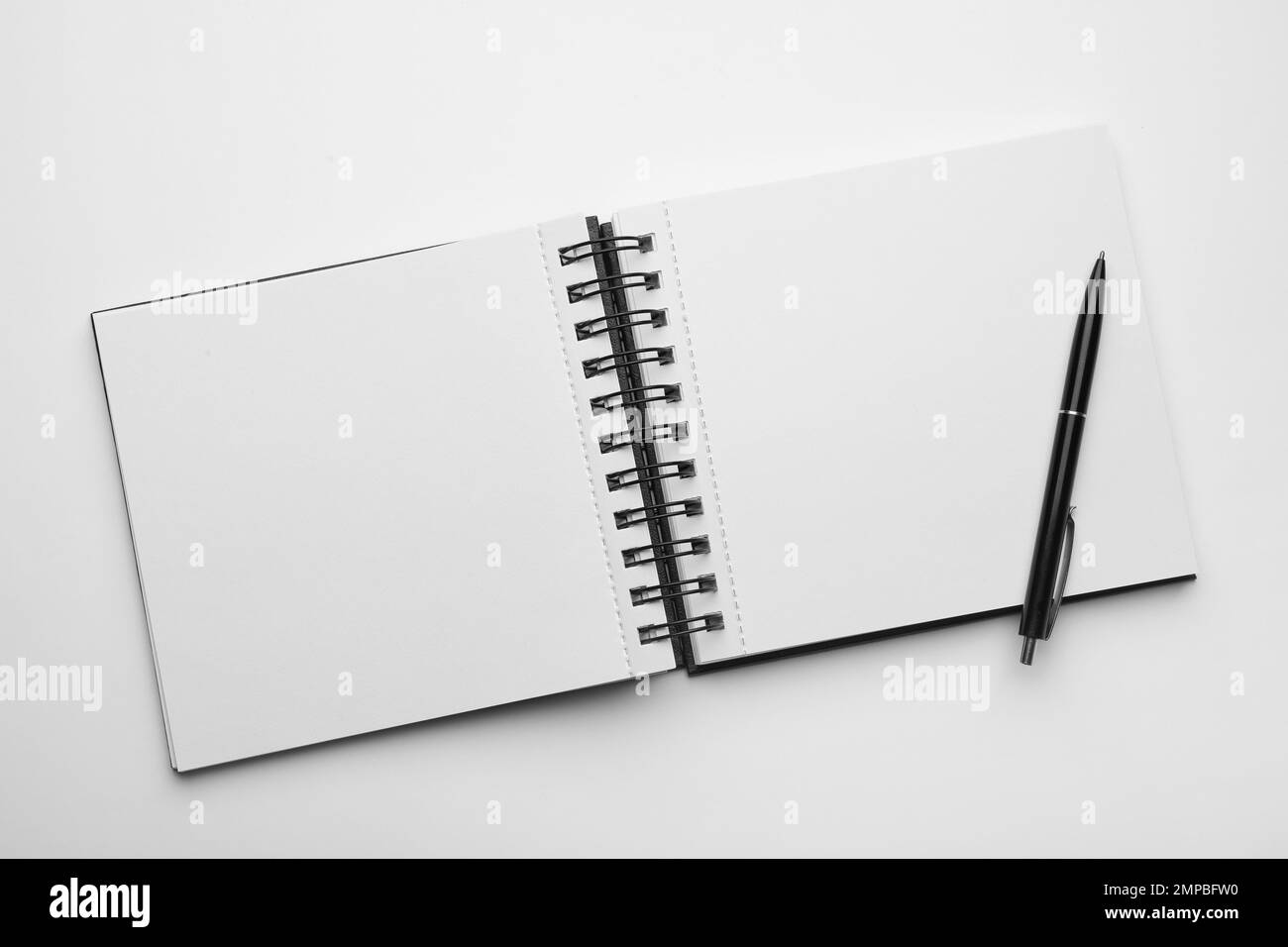 Open empty notebook and pen isolated on white, top view Stock Photo - Alamy