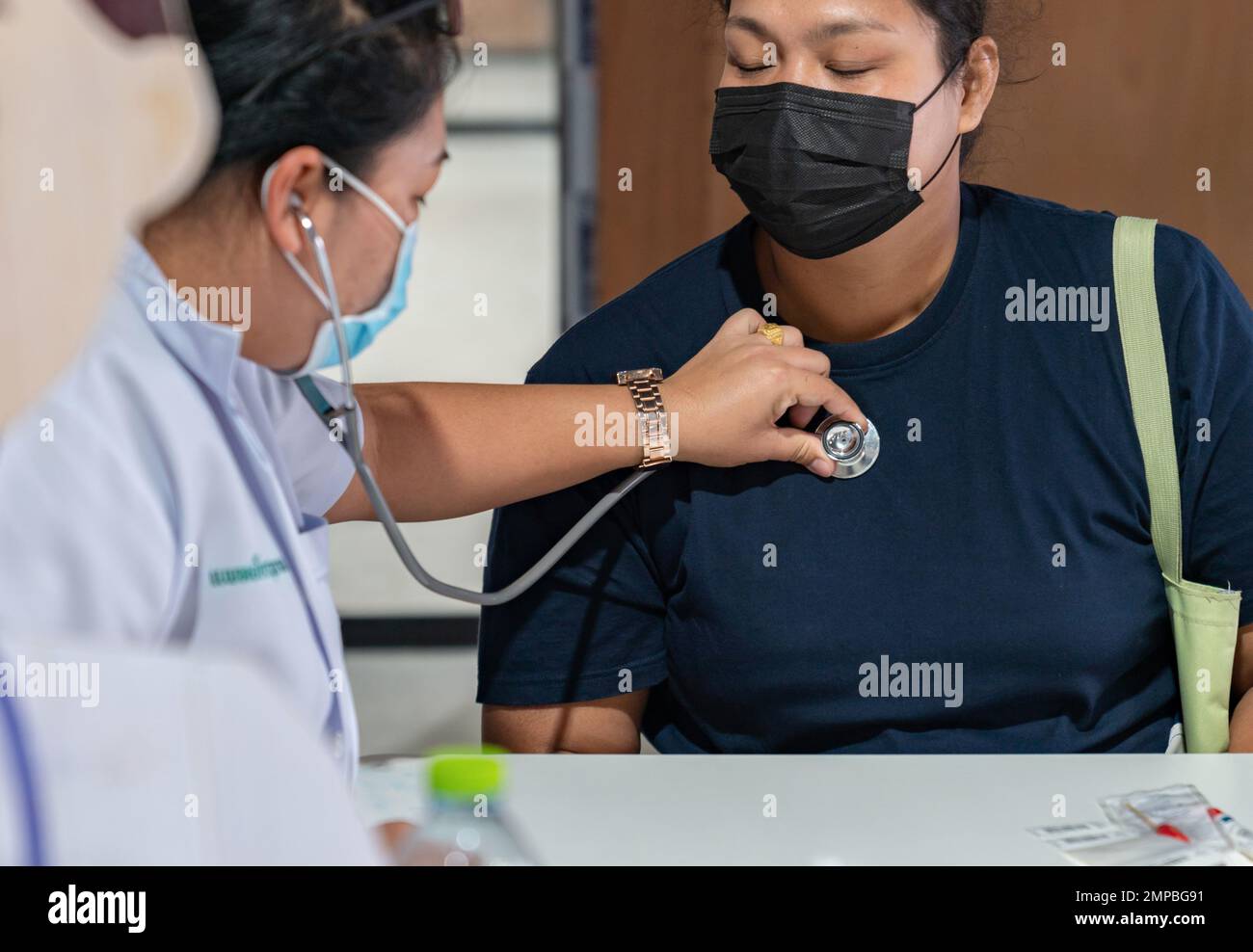The doctor uses a stethoscope to examine the patient's heart rhythm ...