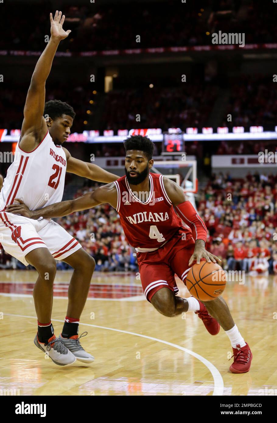 Indiana's Robert Johnson (4) drives against Wisconsin's Khalil Iverson ...