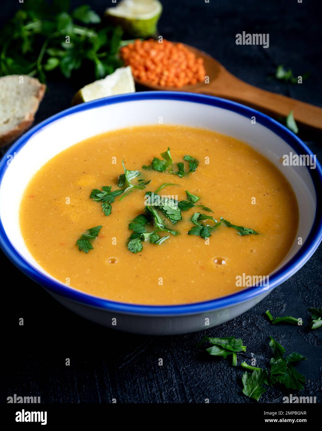 Red lentil soup puree in a bowl on dark background. Traditional middle ...