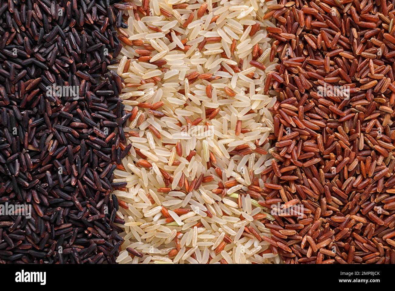 Different types of brown rice as background, top view Stock Photo - Alamy