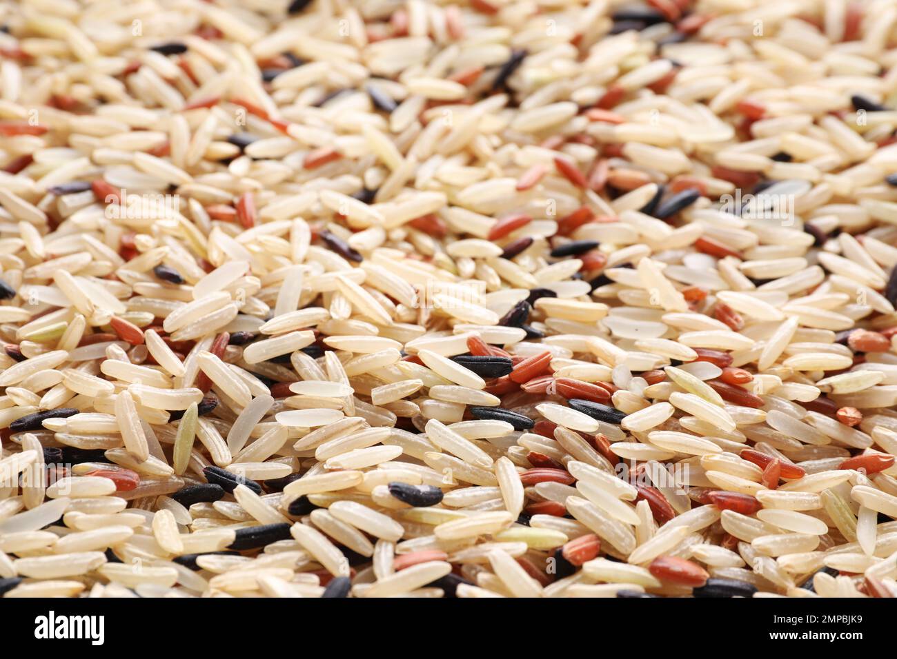 Mix of different brown rice as background, closeup Stock Photo - Alamy