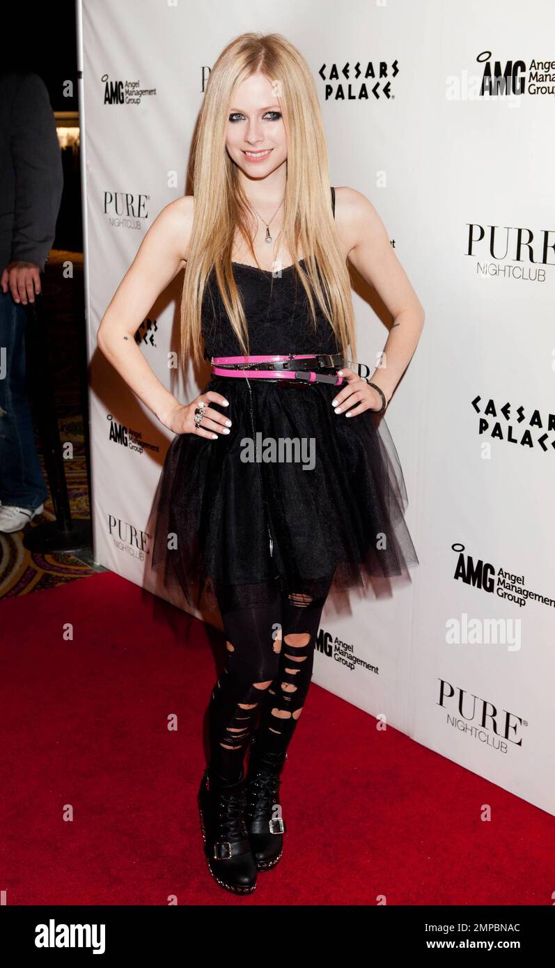 Avril Lavigne wears a black tutu dress, ripped tights and studded boots ...