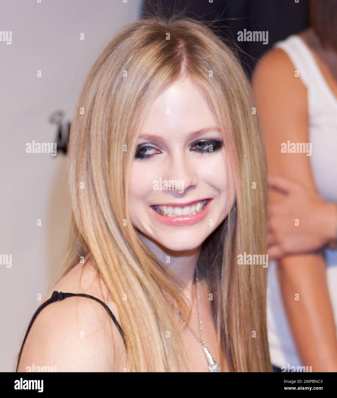 Avril Lavigne wears a black tutu dress, ripped tights and studded boots ...