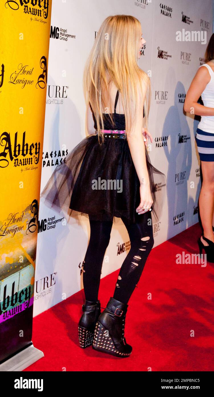 Avril Lavigne wears a black tutu dress, ripped tights and studded boots ...