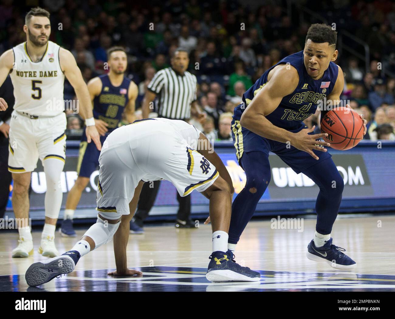 Georgia Tech's Brandon Alston (4) drives in as Notre Dame's Bonzie ...
