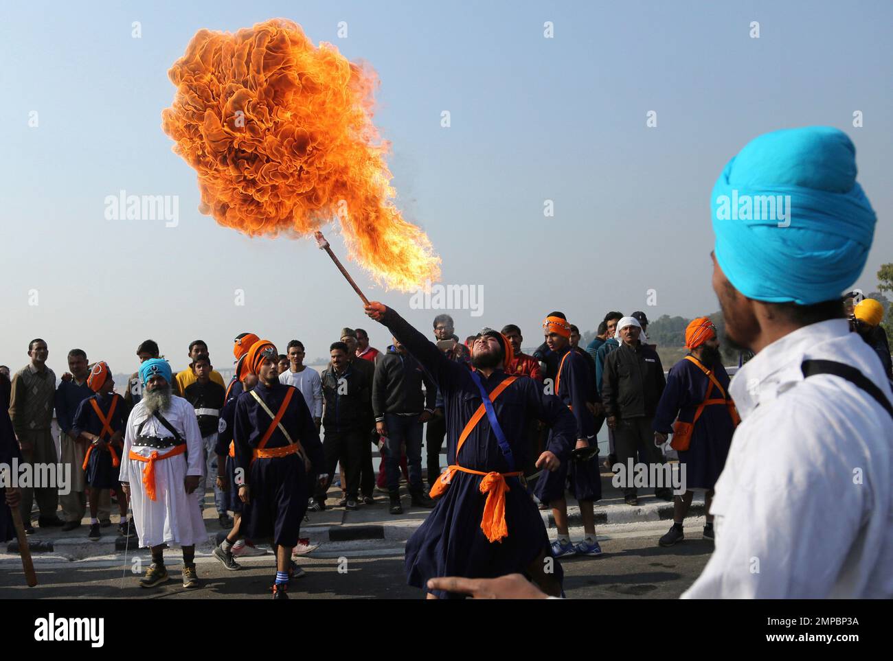 An Indian Sikh warrior performs a fire act as he displays traditional ...