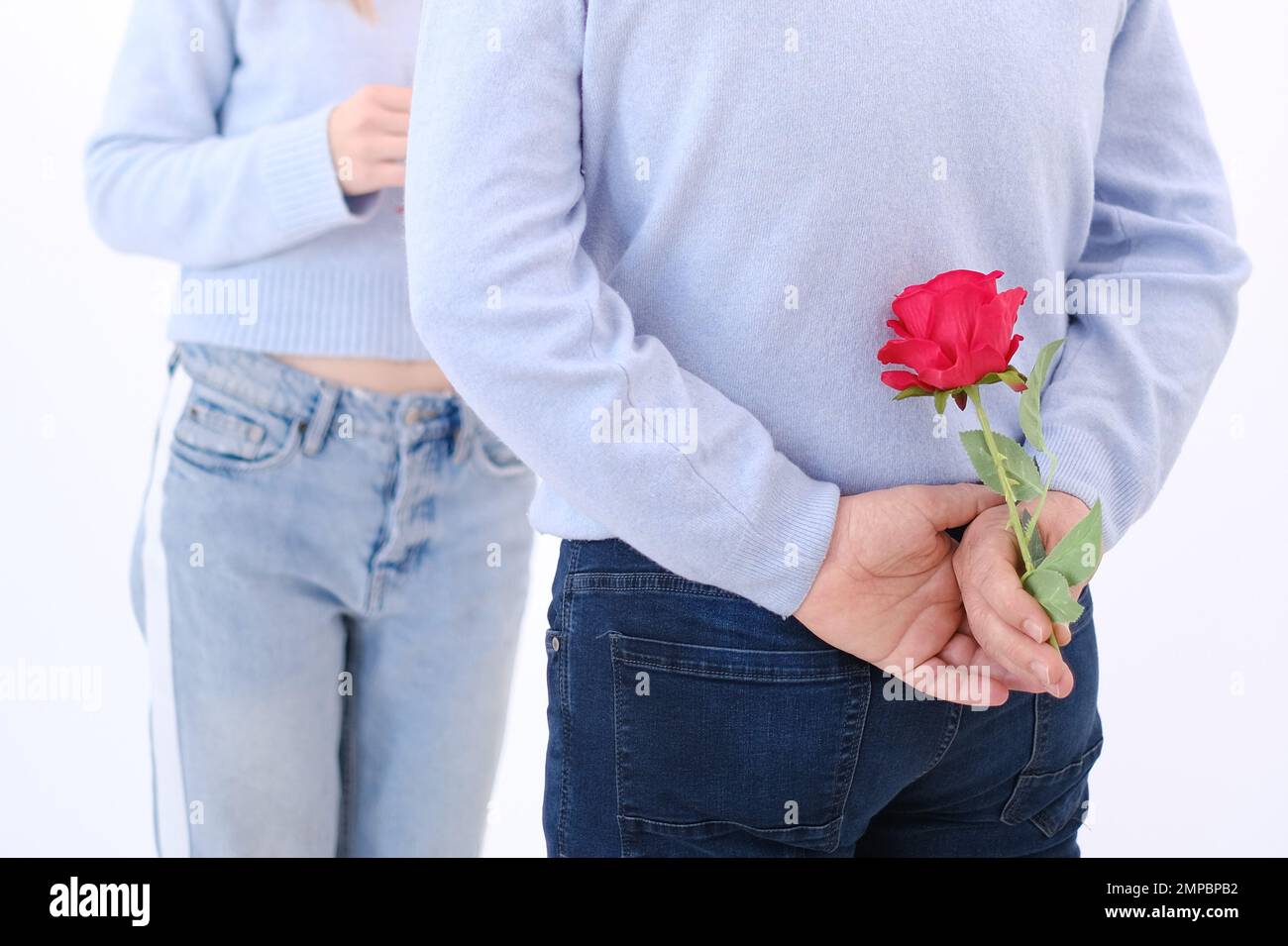 Man hiding rose behind back hi-res stock photography and images - Alamy