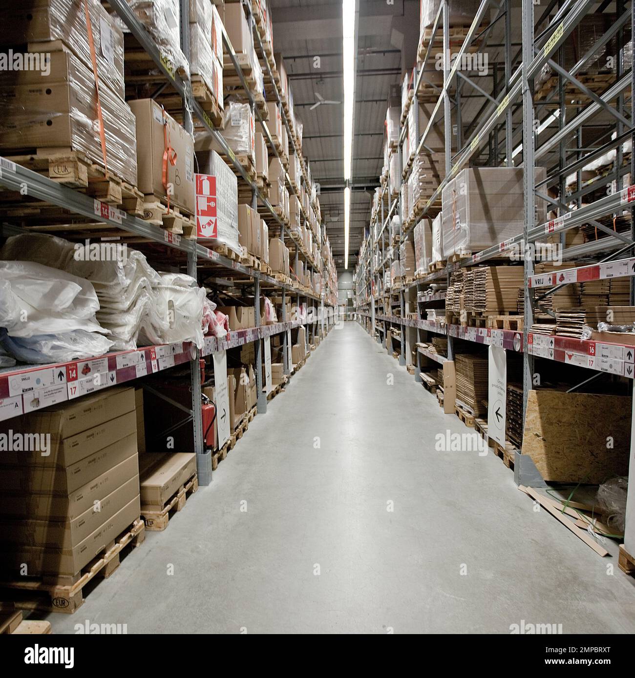 Large warehouses and female customers are choosing products. Blurred ...