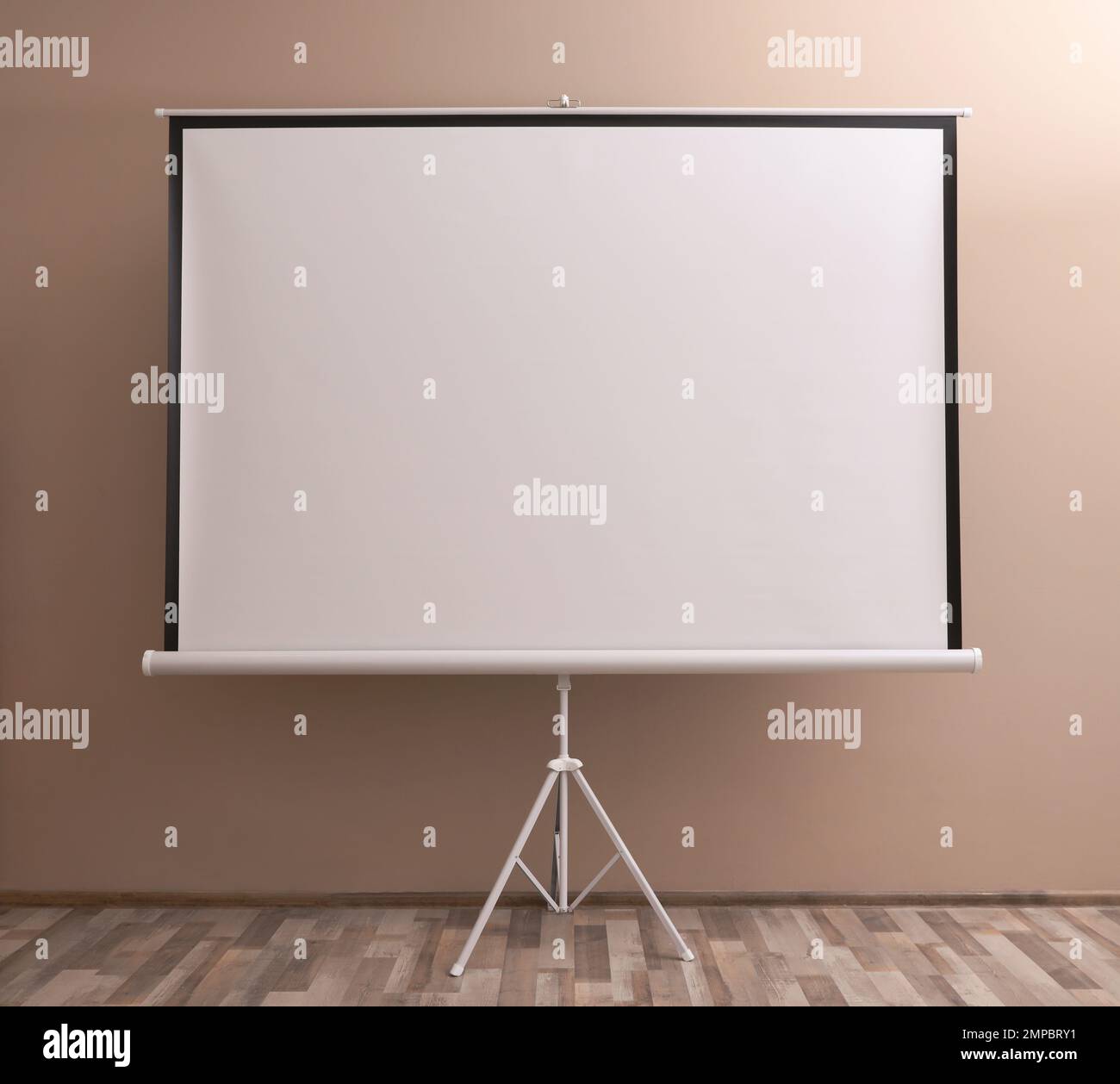 Blank projection screen near beige wall indoors. Space for design Stock ...