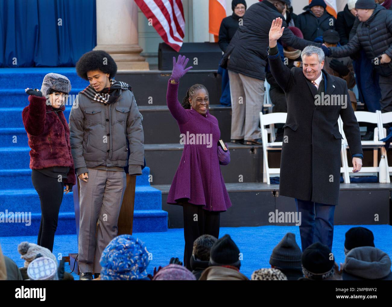 New York Mayor Bill de Blasio, right, and his family wave to onlookers ...