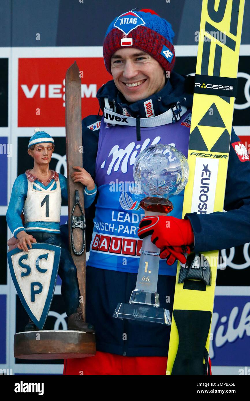 Winner Kamil Stoch of Poland celebrates on the podium after winning the ...