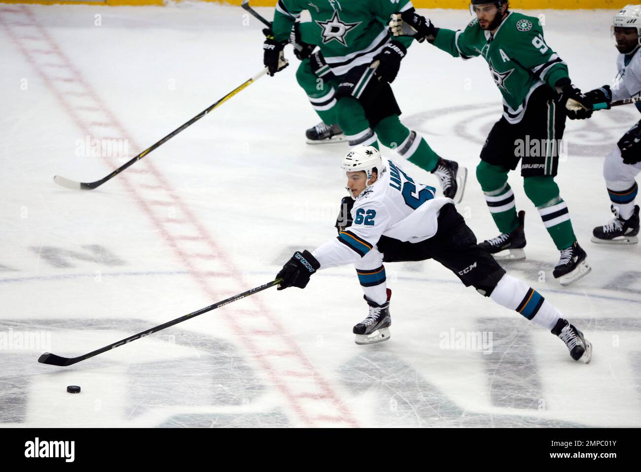 San Jose Sharks right wing Kevin Labanc (62) reaches for the puck as ...