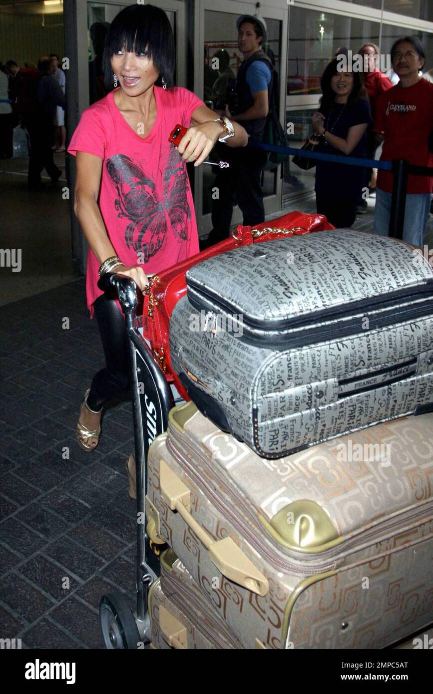 Actress Bai Ling arrives at LAX and pushes her own luggage cart, which ...