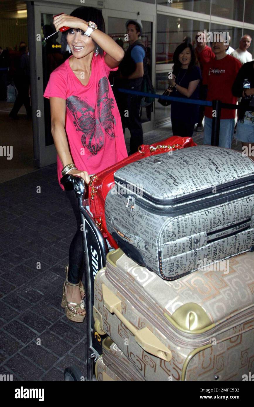 Actress Bai Ling arrives at LAX and pushes her own luggage cart, which ...