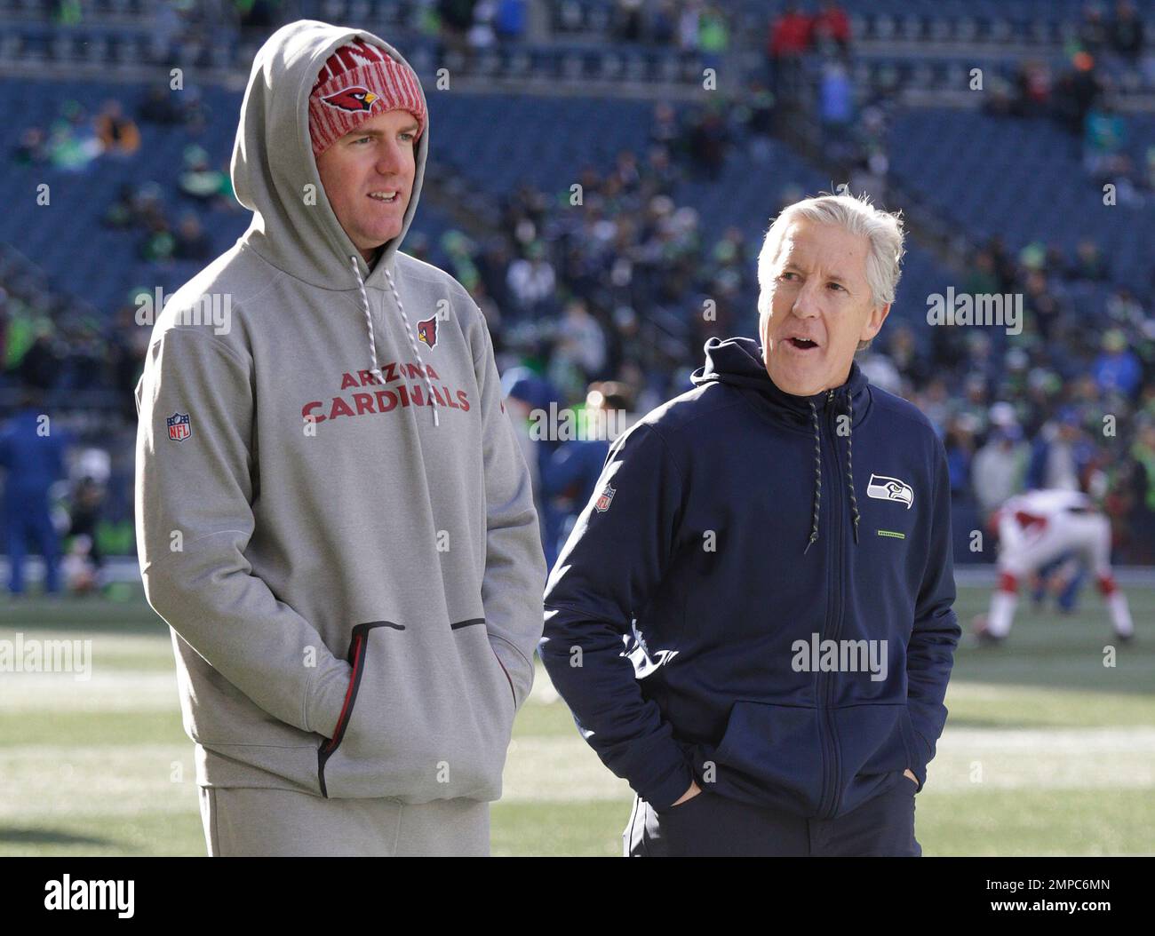 Injured Arizona Cardinals quarterback Carson Palmer, left, walks with ...