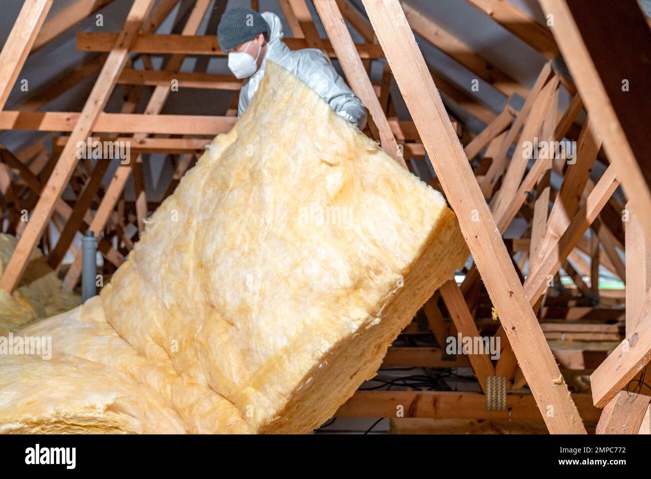 insulation of the roof and ceiling with glass wool Stock Photo - Alamy