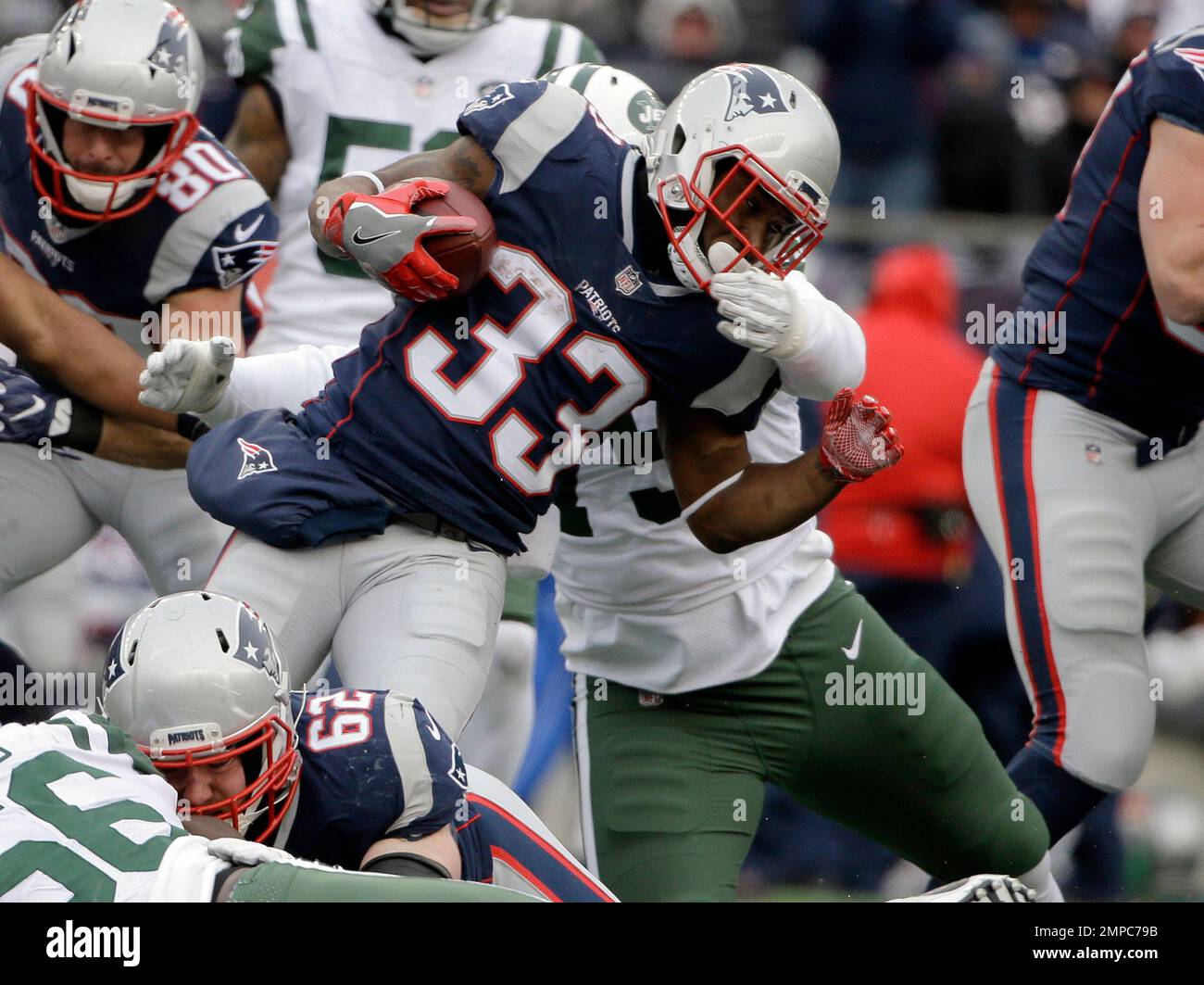 New York Jets defensive end Xavier Cooper, rear, tackles New England ...
