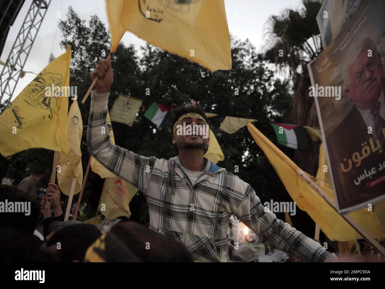 Marchers chants slogans and wave party flags during a rally marking the ...