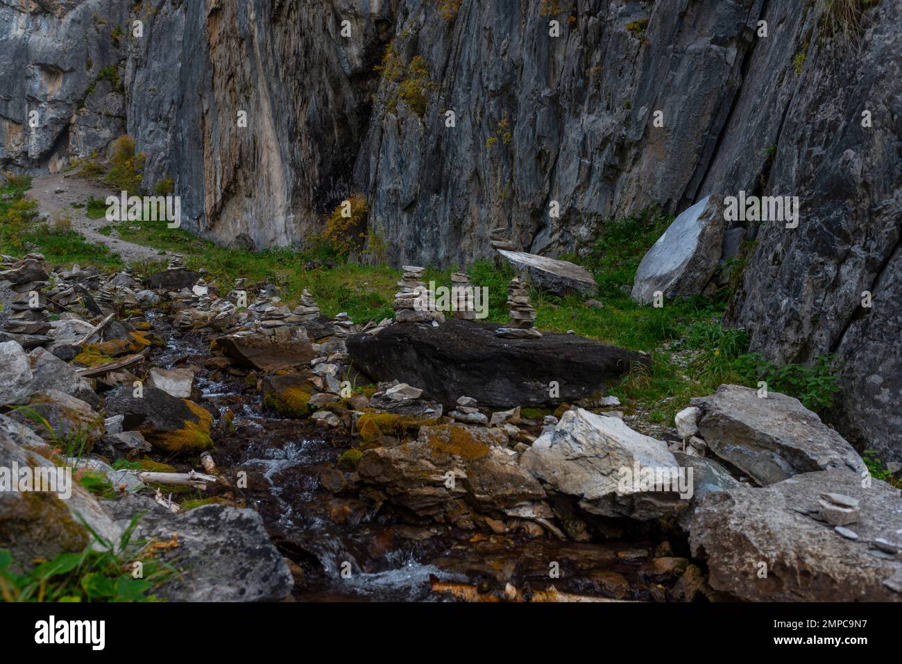 Stones piled on top of each other along the path goes to the stone wall ...