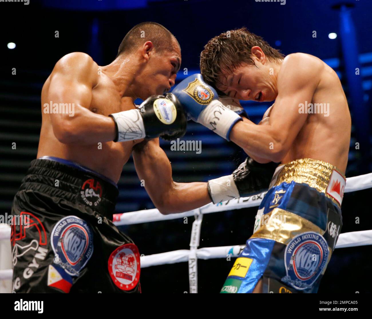 WBA champion Ryoichi Taguchi, right, of Japan gets a punch from IBF ...