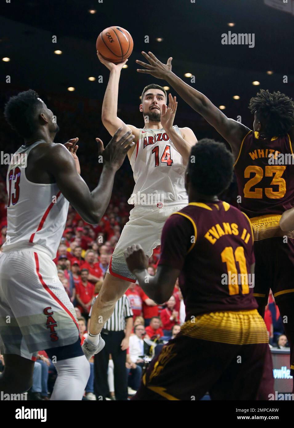 Arizona center Dusan Ristic shoots as Arizona State's Romello White (23 ...