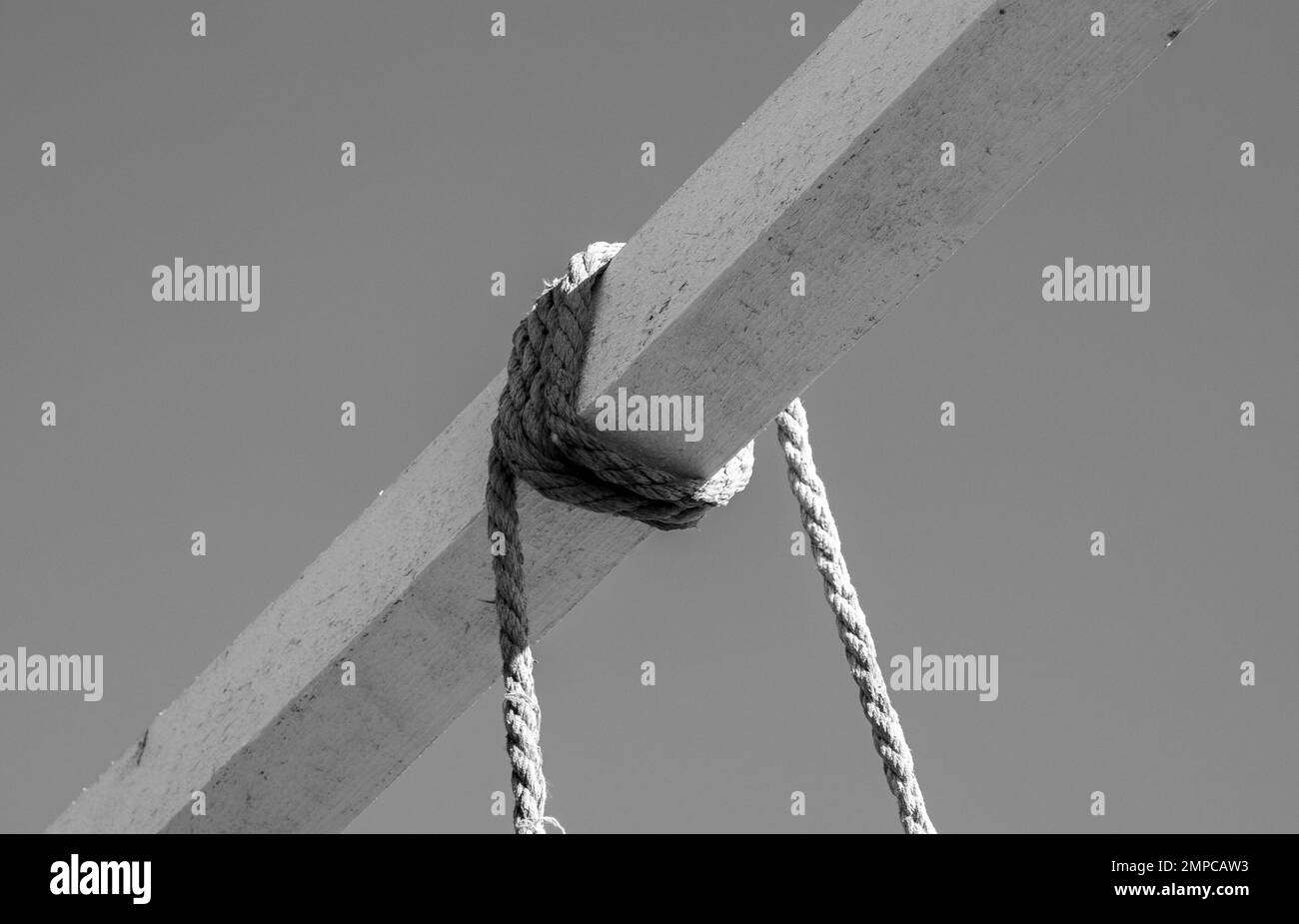 A close-up of a rope wrapped around a beam in black and white Stock ...