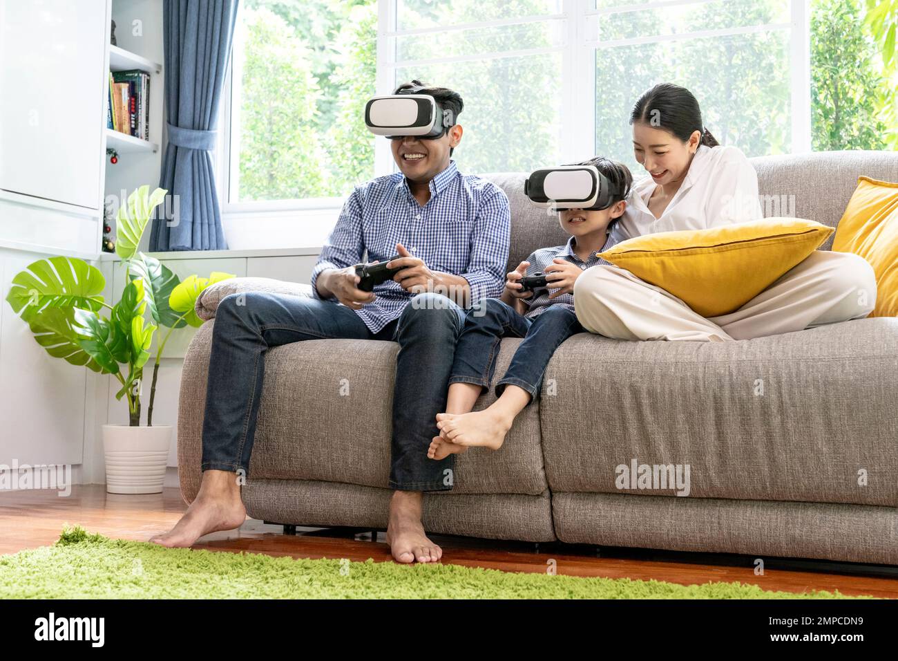 Small family having fun with vr headset at home - Virtual reality and ...