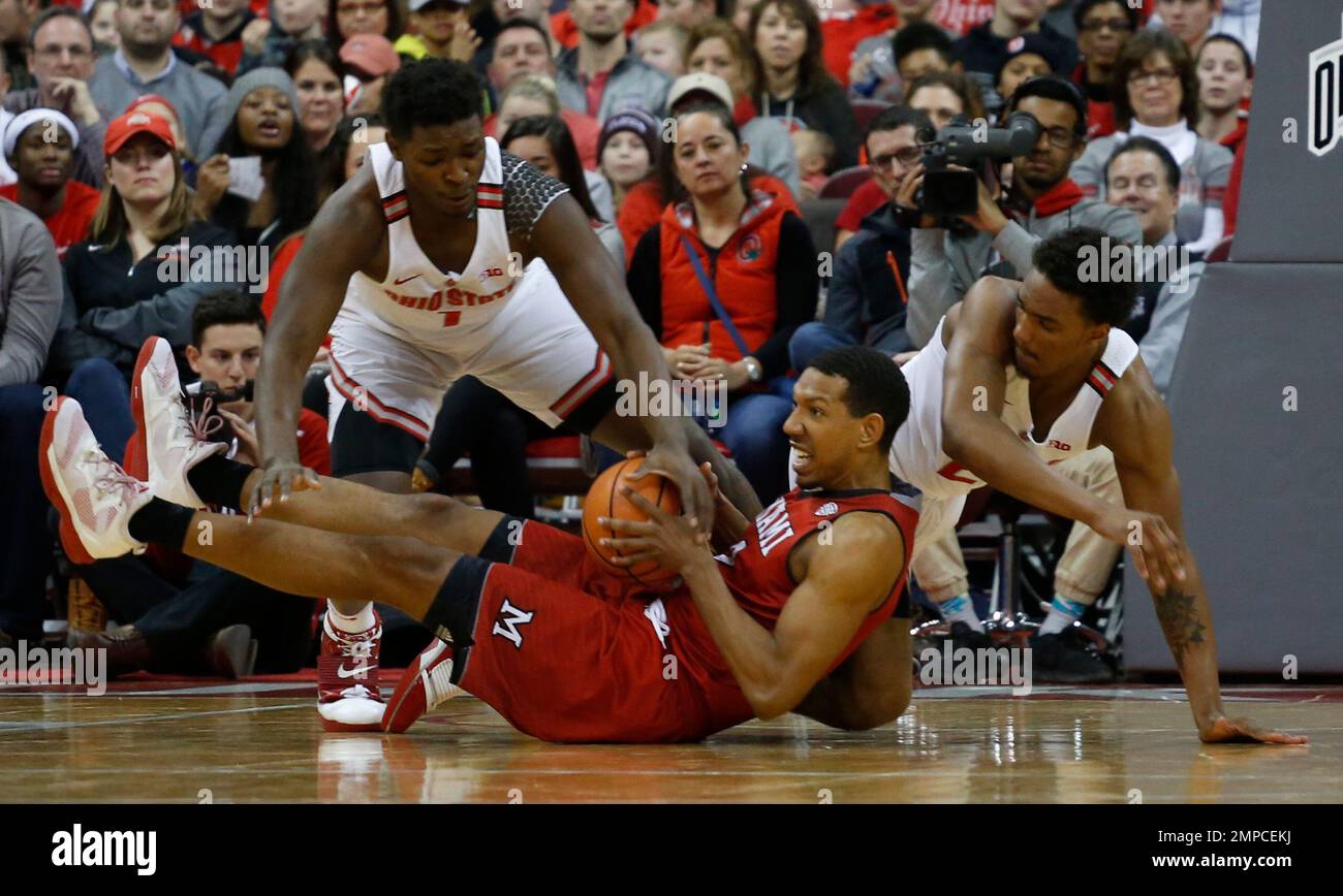 Miami of Ohio's Rod Mills, center, grabs a loose ball from Ohio State's ...