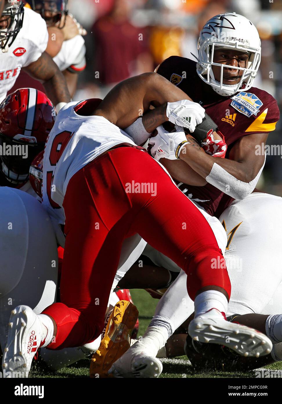 Arizona State running back Kalen Ballage, right, is brought down by ...
