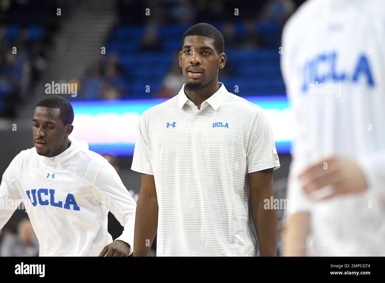 Suspended UCLA basketball player Cody Riley, center, watches his ...
