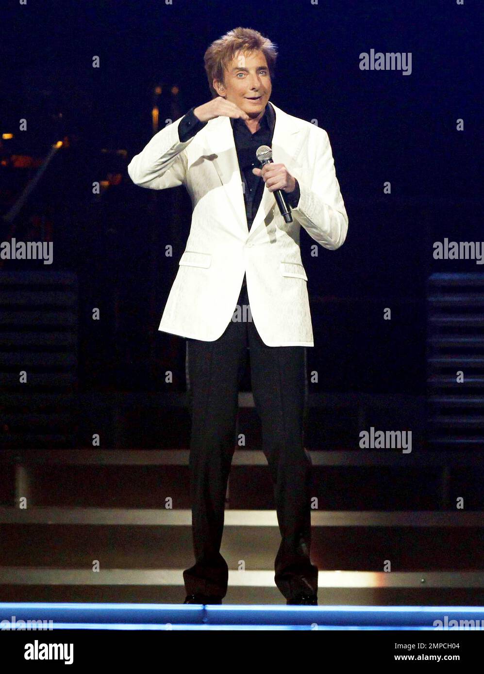 In a white jacket three piece tuxedo Barry Manilow performs live at ...