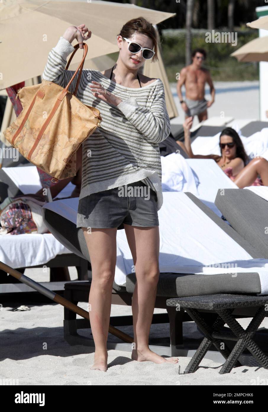 Mischa Barton shows of her enviable slim figure in a black bikini as she relaxes on the beach ...