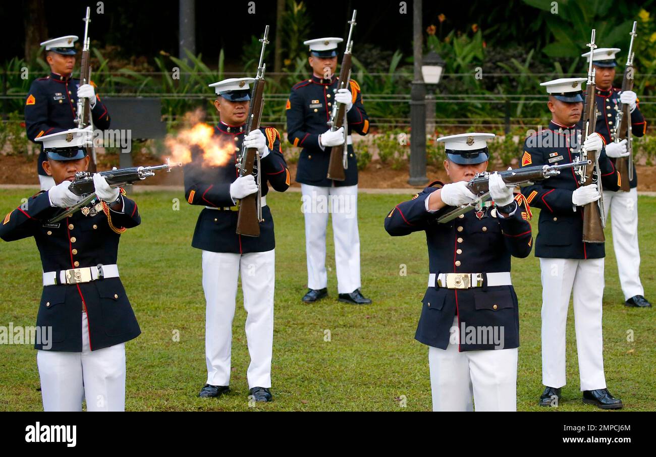 Philippine marines fire their rifles for a 21-gun salute during wreath ...