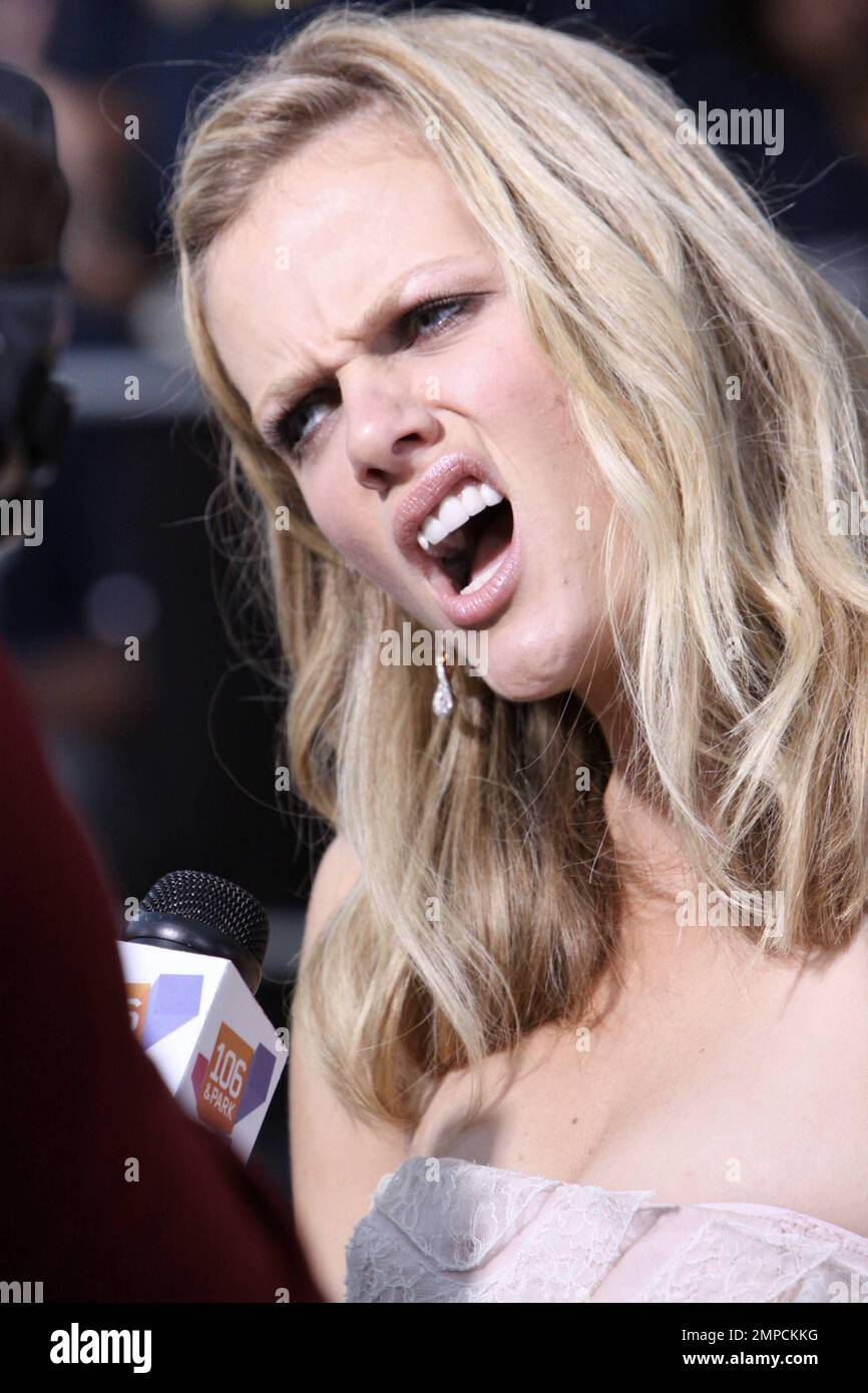 Wearing a tan lace strapless dress with tan strappy high heels ...