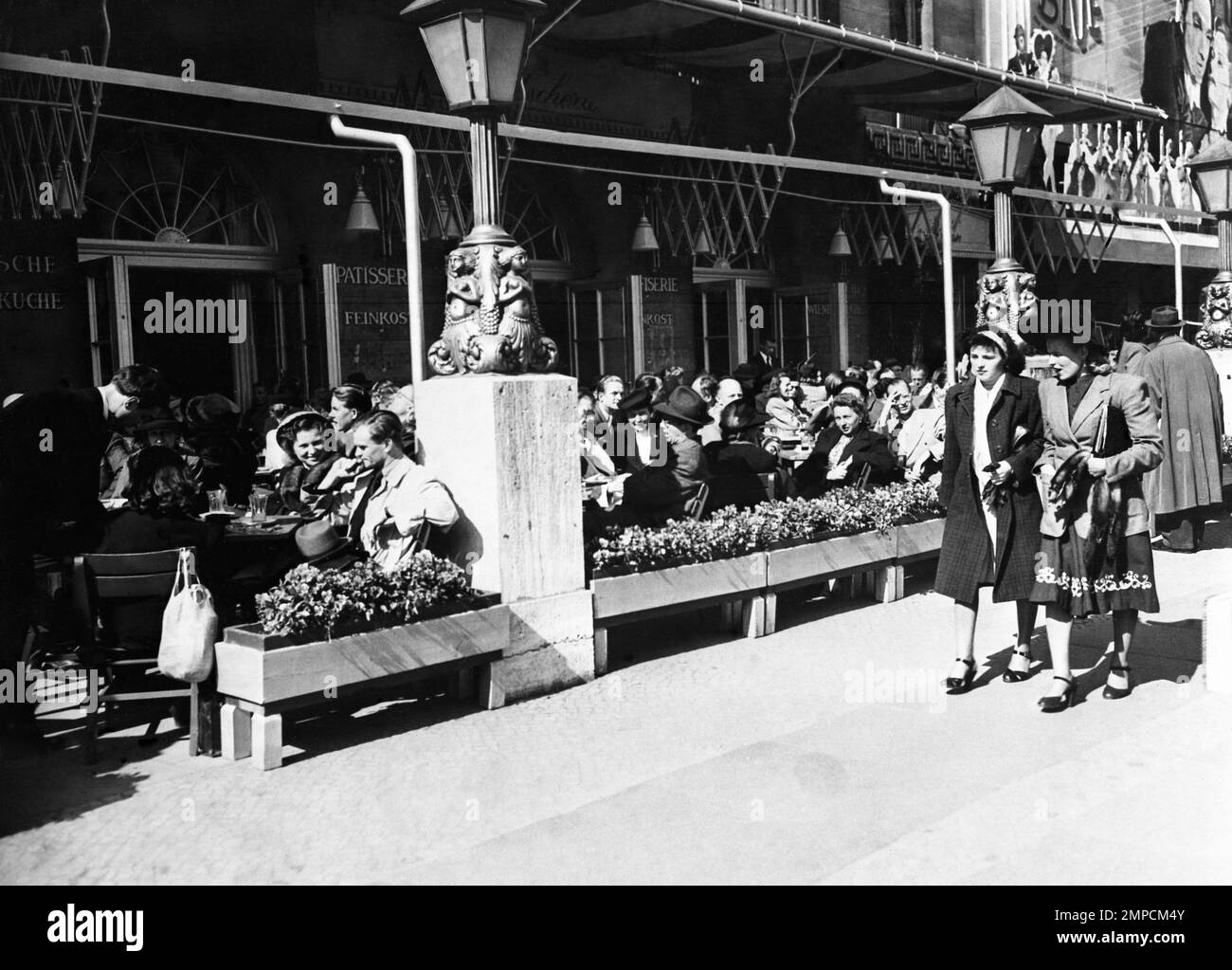 Well dressed Berliners walk past the Kurfuerstendamm's most popular ...