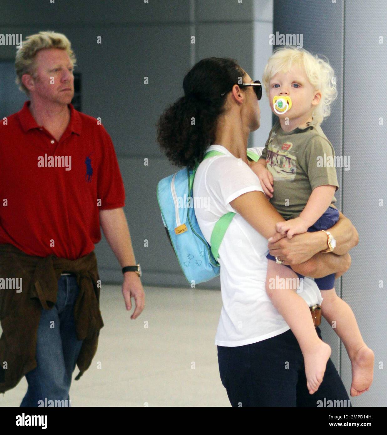Boris Becker makes his way through Miami International Airport with his ...