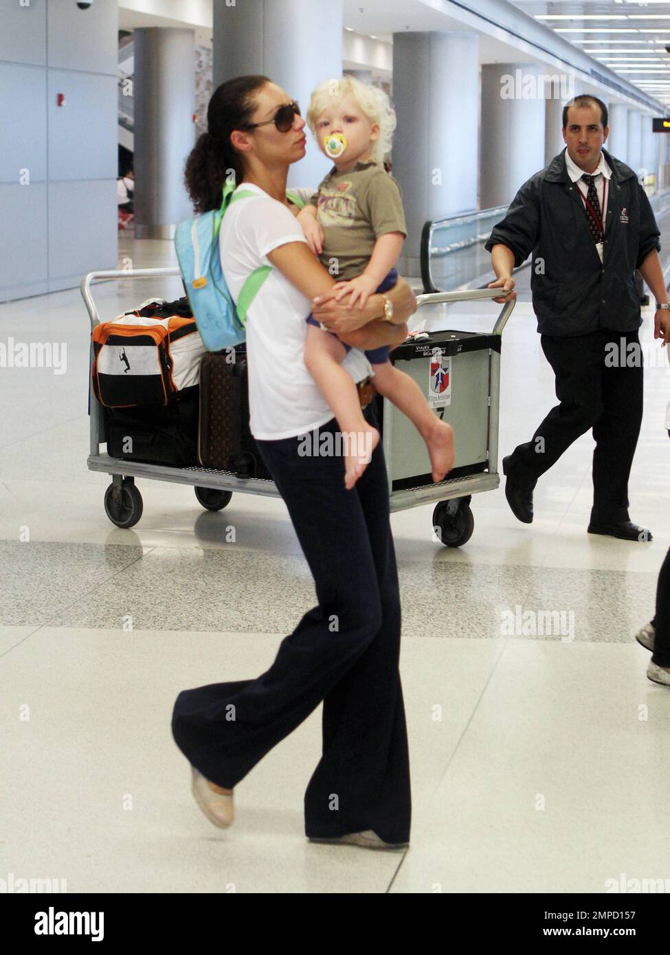 Boris Becker makes his way through Miami International Airport with his ...