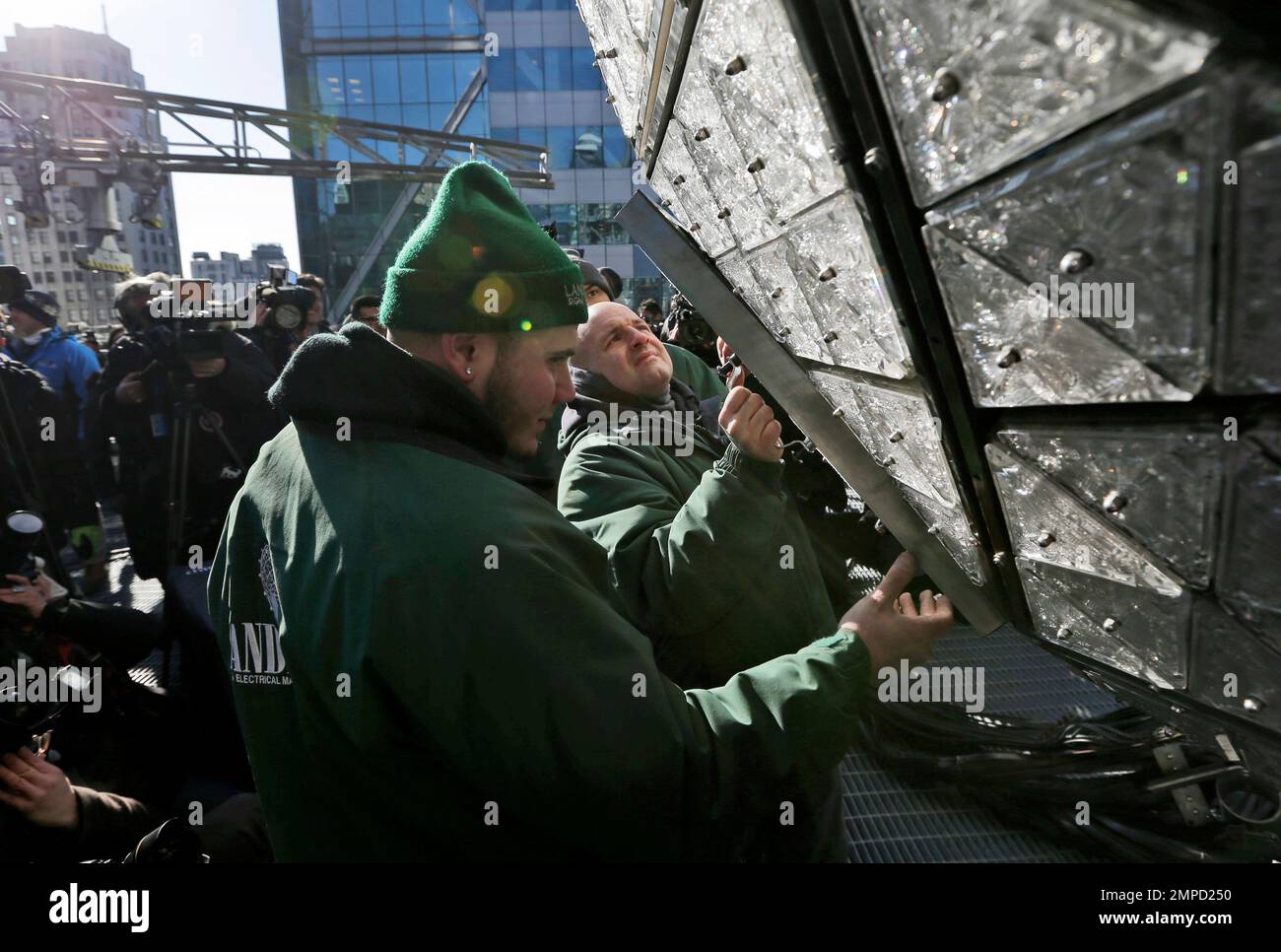 Workers install the last panels on the New Year's Eve ball above Times ...