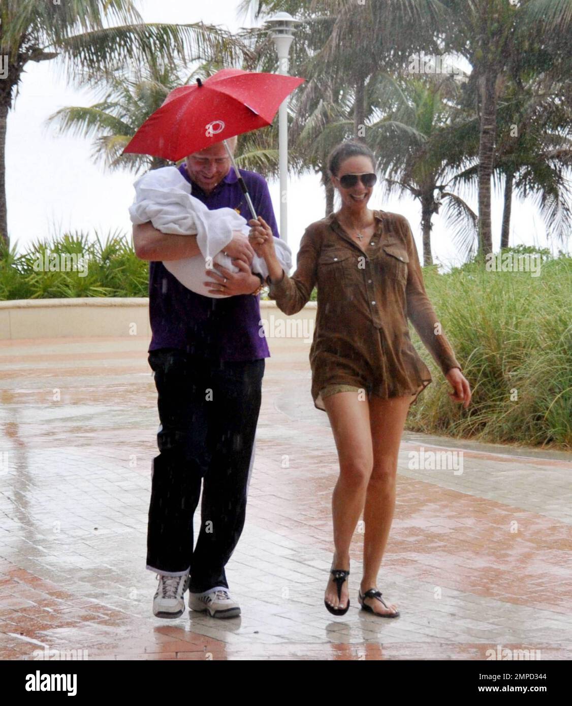 Boris Becker takes a walk in the rain with his wife Sharlely, son Elias ...