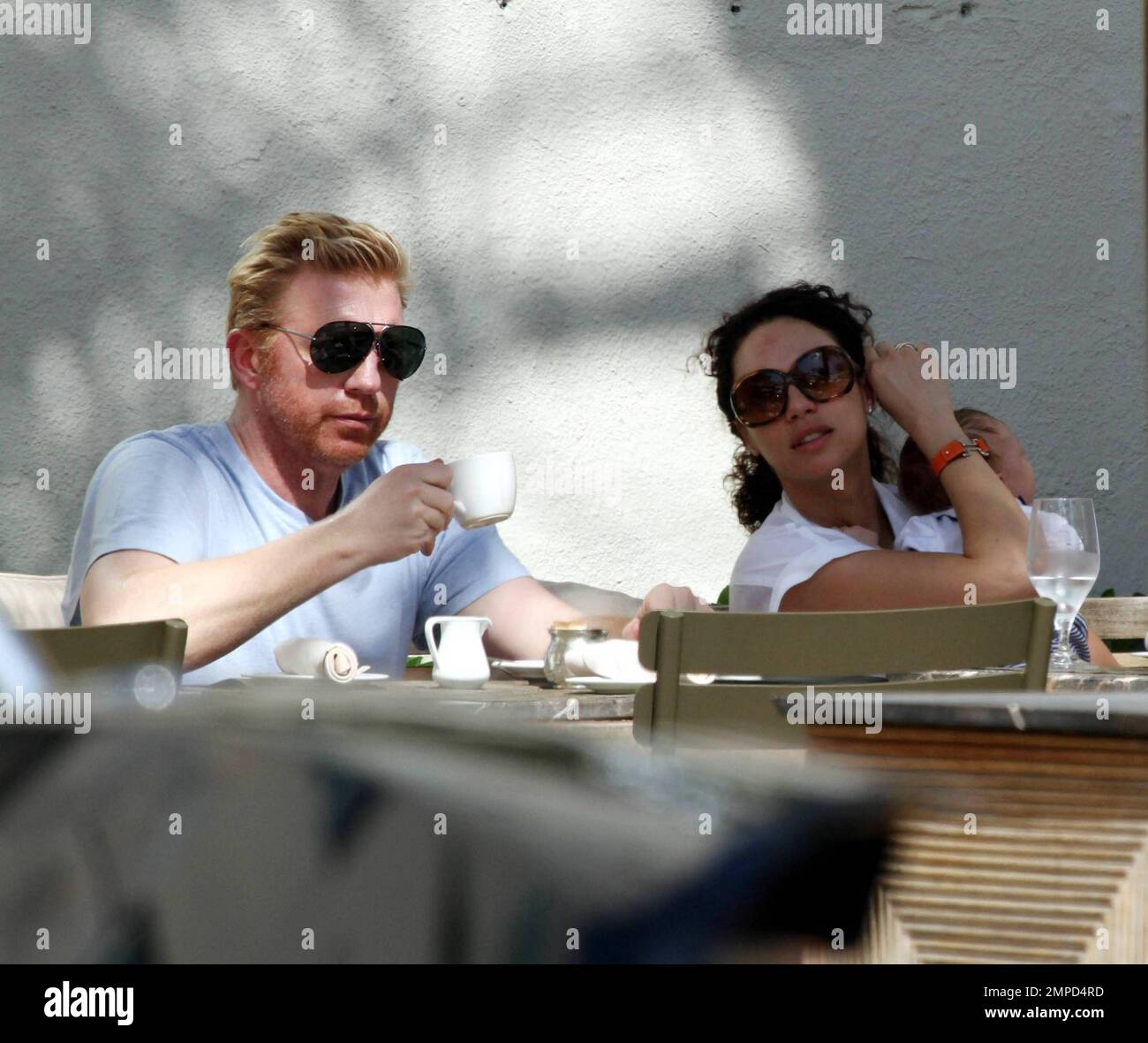 Tennis ace Boris Becker walks along Miami Beach boardwalk yawning and ...