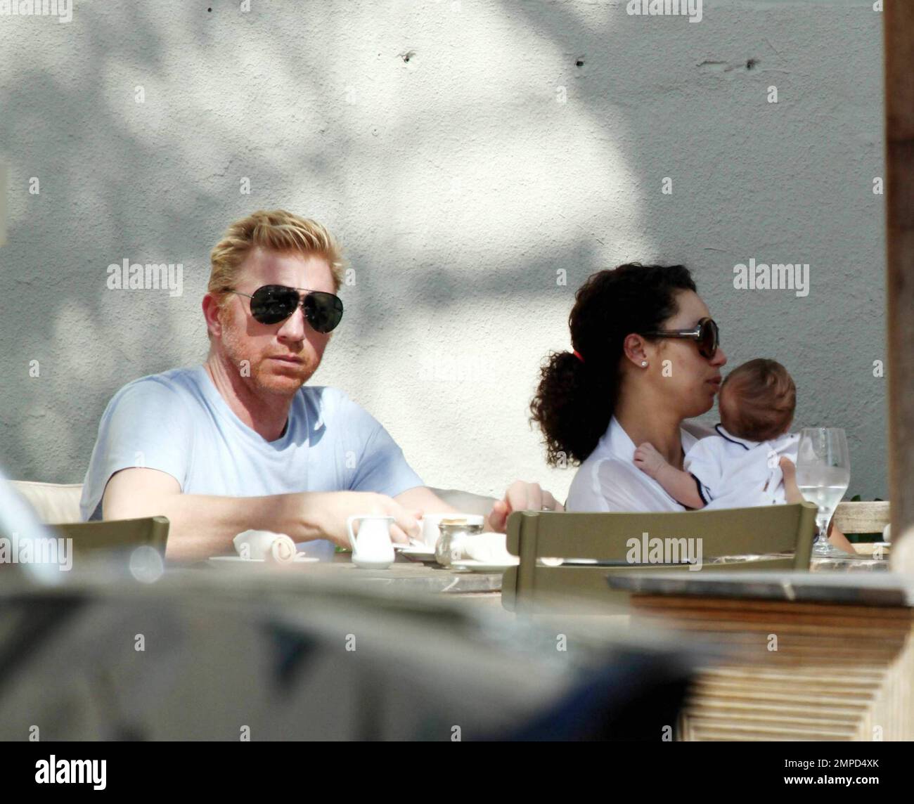 Tennis ace Boris Becker walks along Miami Beach boardwalk yawning and ...